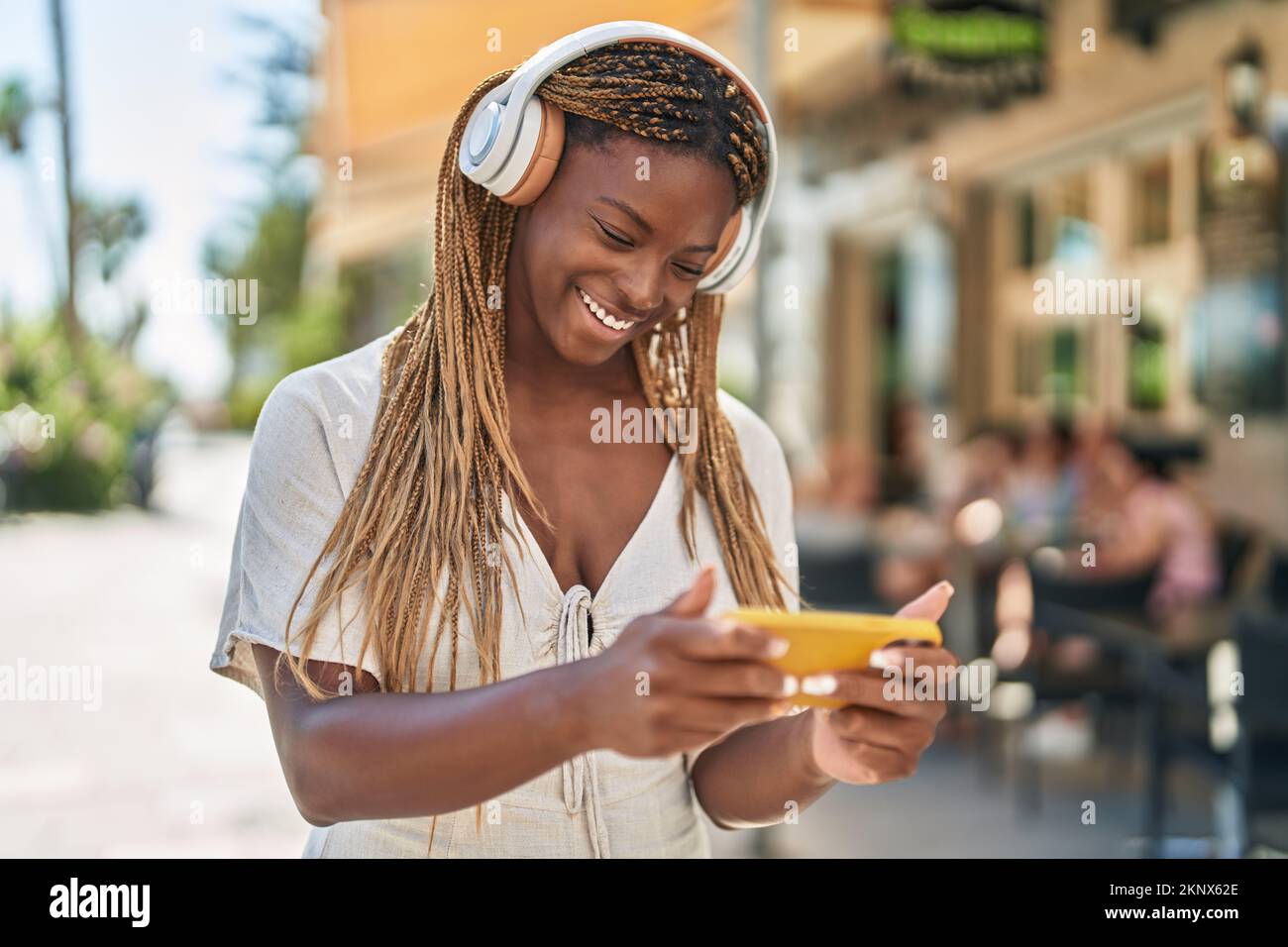 African american woman smiling confident playing video game at pharmacy ...