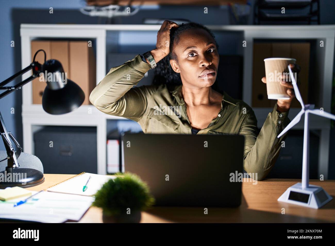 African woman working using computer laptop at night confuse and ...