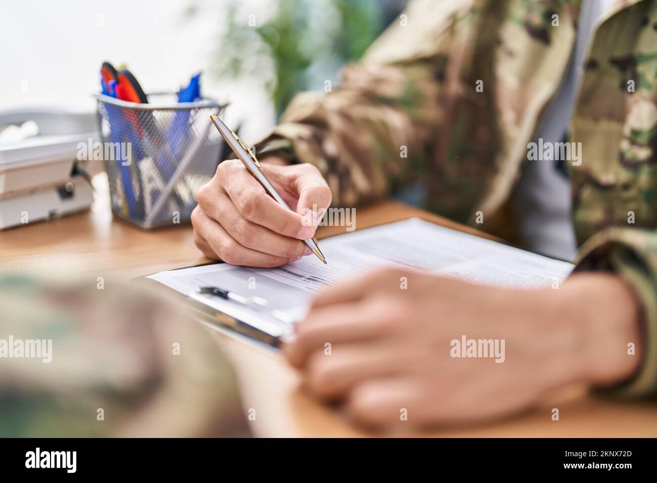 Young hispanic man army soldier signing contract at office Stock Photo ...