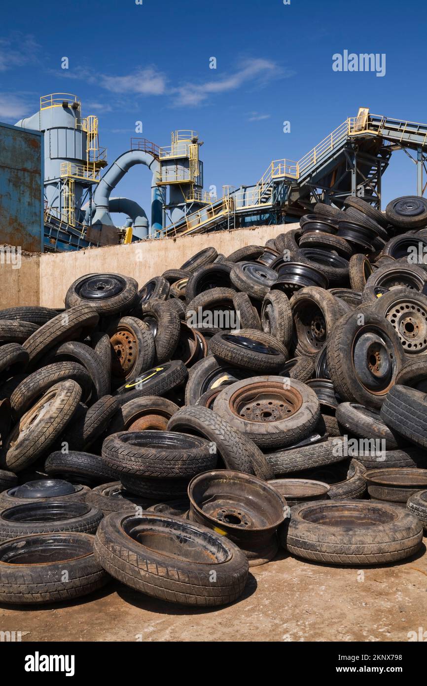 Pile of discarded truck tires in bin at scrap metal recycling yard ...