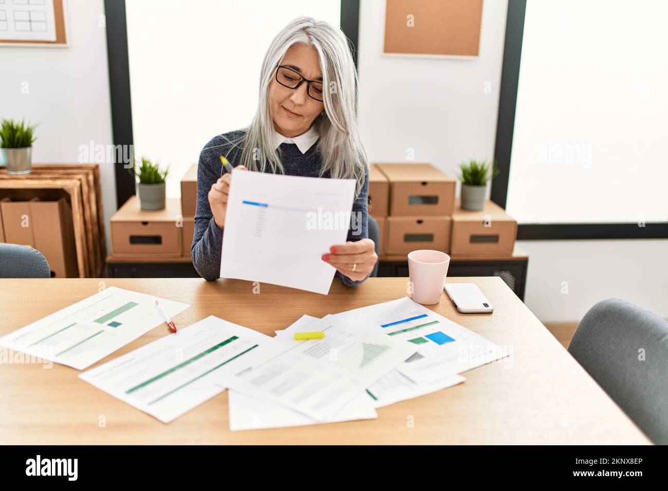 Middle age grey-haired woman business worker smiling confident working ...