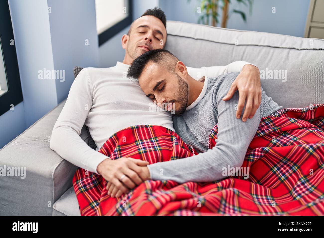 Two men couple lying on sofa sleeping at home Stock Photo - Alamy