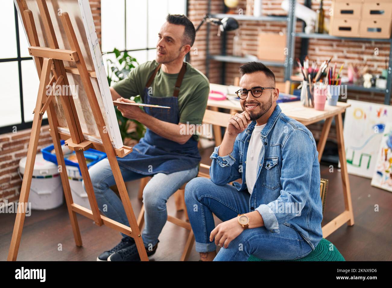 Two men artists smiling confident drawing at art studio Stock Photo - Alamy