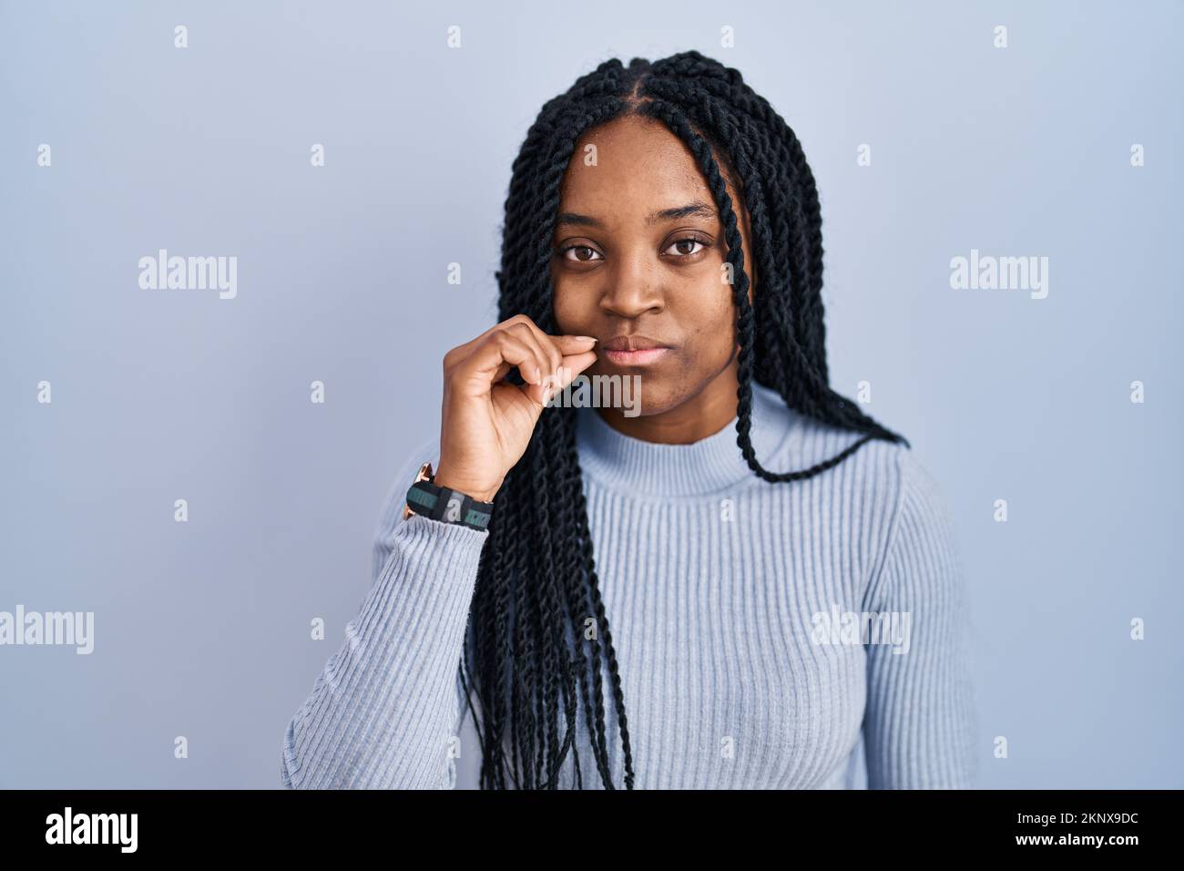 African american woman standing over blue background mouth and lips ...
