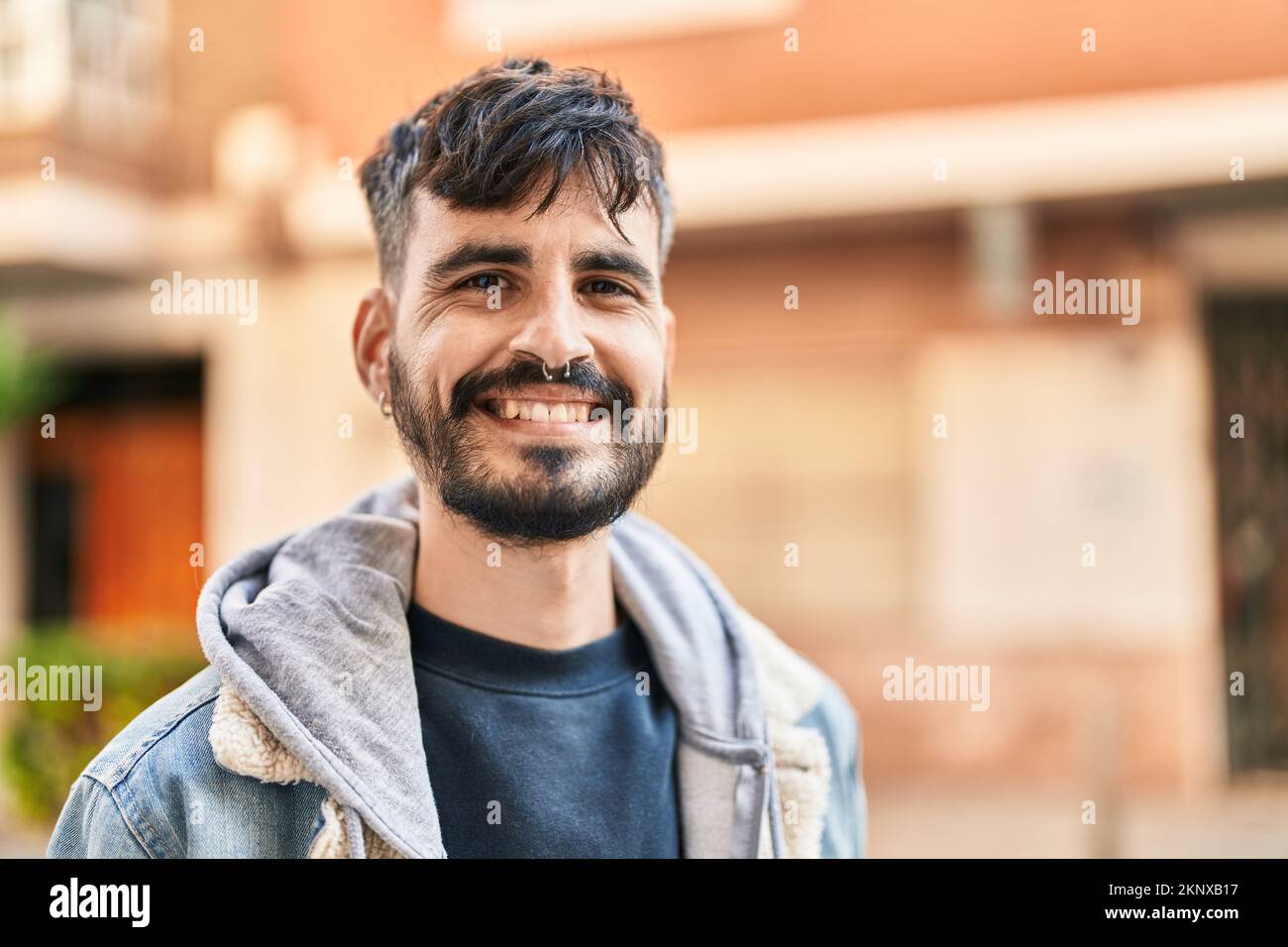 Young hispanic man smiling confident standing at street Stock Photo - Alamy
