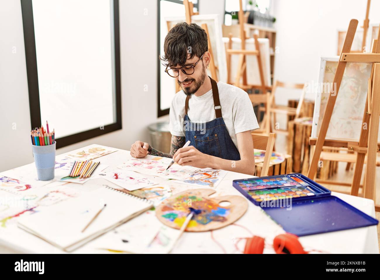 Young hispanic artist man smiling happy drawing at art studio Stock ...