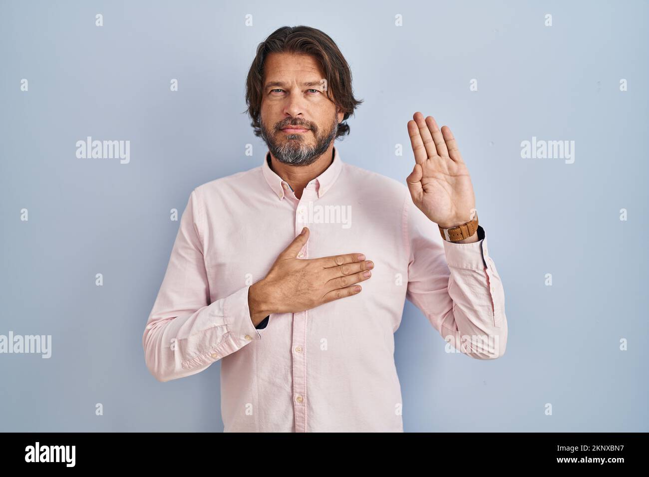 Handsome middle age man wearing elegant shirt background swearing with ...