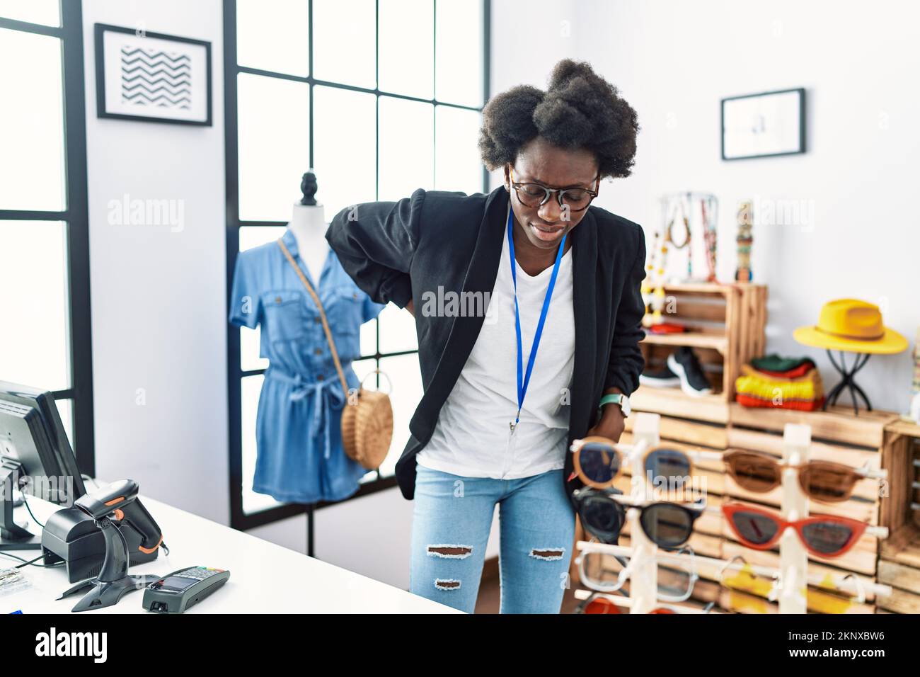 African young woman working as manager at retail boutique suffering of ...