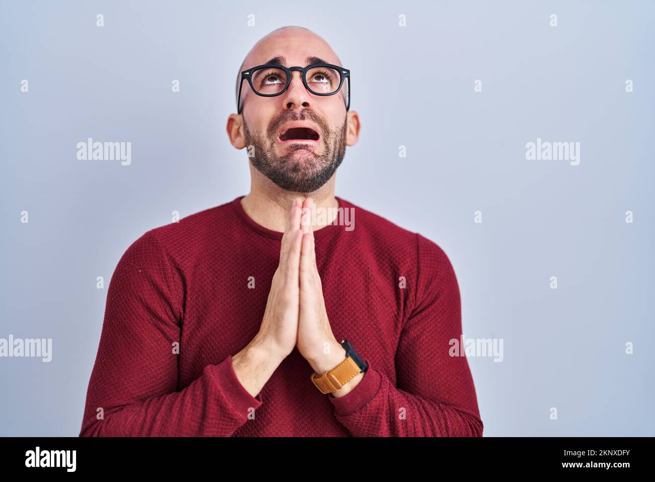 Young bald man with beard standing over white background wearing ...