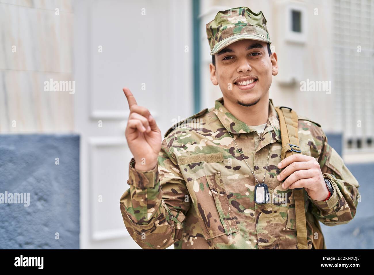 Young arab man wearing camouflage army uniform outdoors smiling happy ...