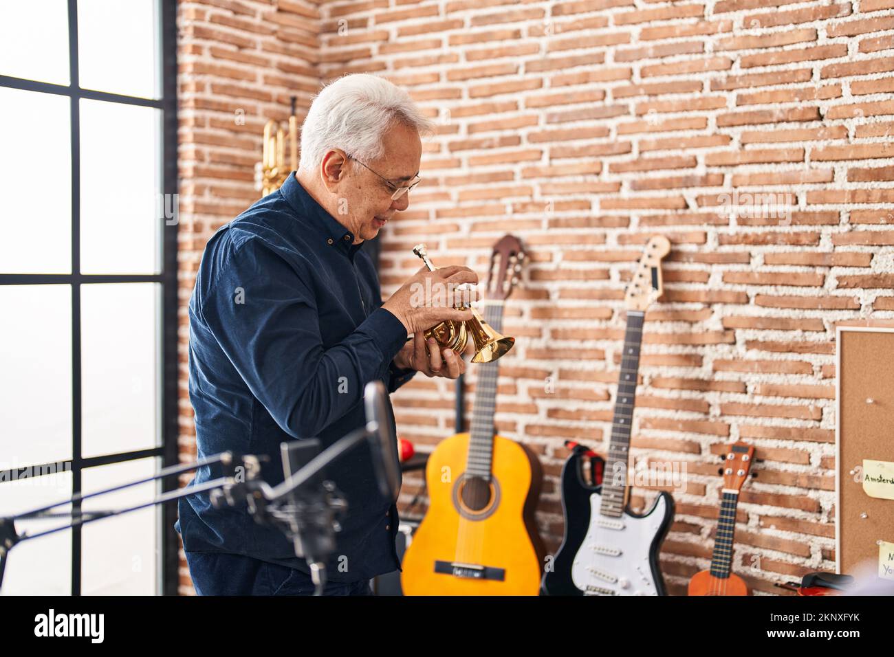Senior man musician playing trumpet at music studio Stock Photo - Alamy