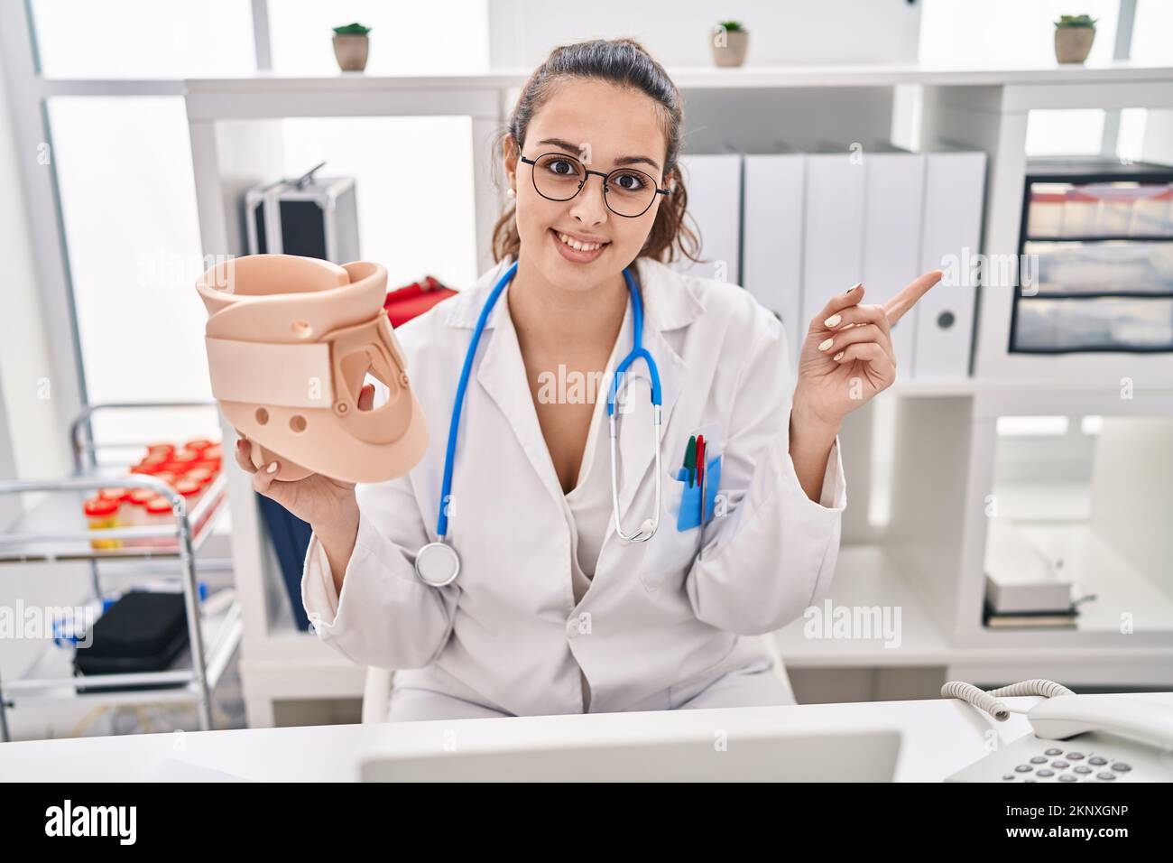 Young hispanic doctor woman holding cervical neck collar smiling happy ...