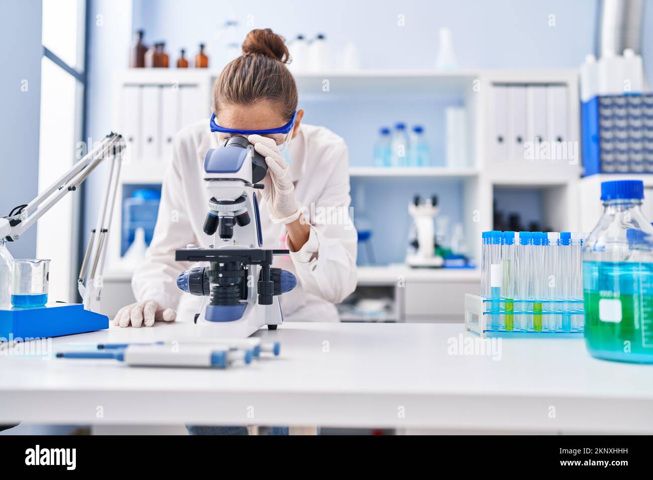 Young woman scientist using microscope working at laboratory Stock ...