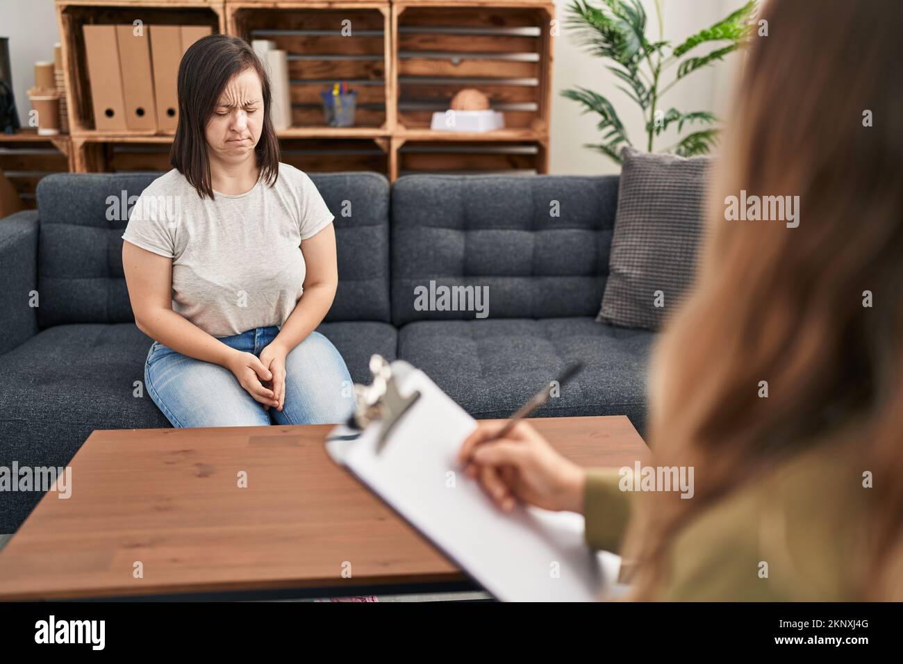 Hispanic girl with down syndrome doing therapy depressed and worry for ...