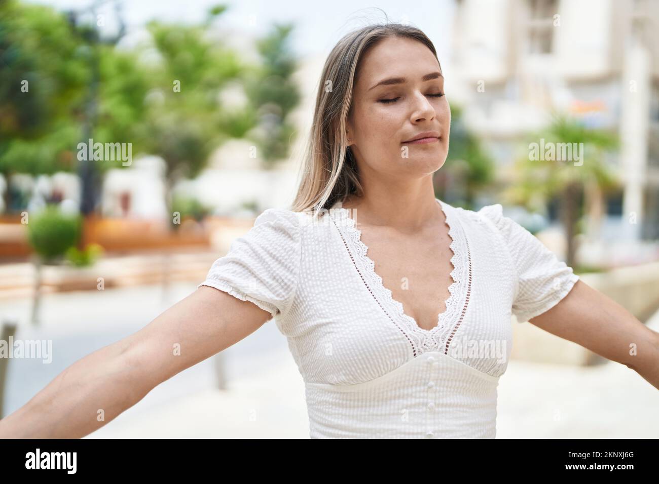 Young caucasian woman smiling confident breathing with arms open at ...