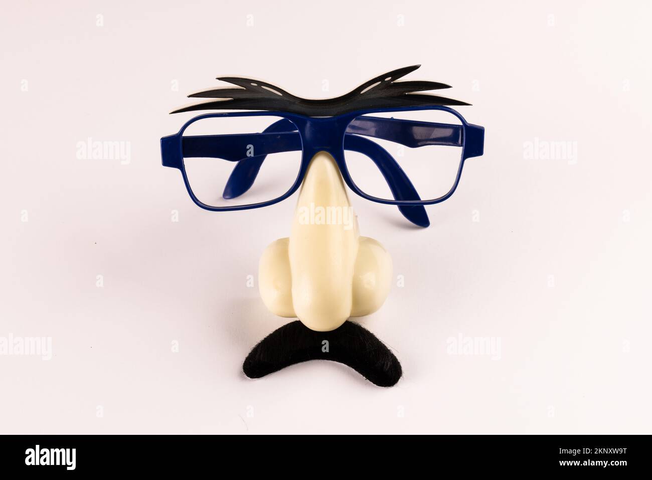 Composition of fake mask with glasses on white background with copy ...