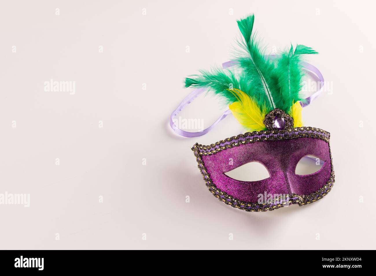 Composition of colourful mardi gras carnival mask with feathers on ...