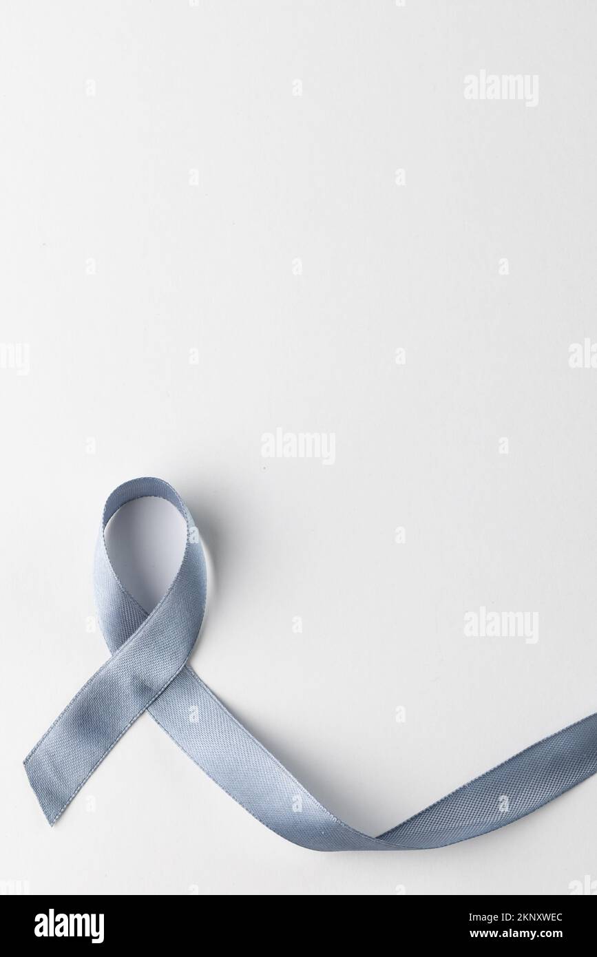 Vertical composition of grey ribbon for cancer awareness, on white ...