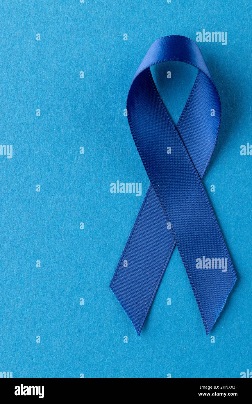 Vertical of blue ribbon for prostate cancer awareness, on blue ...