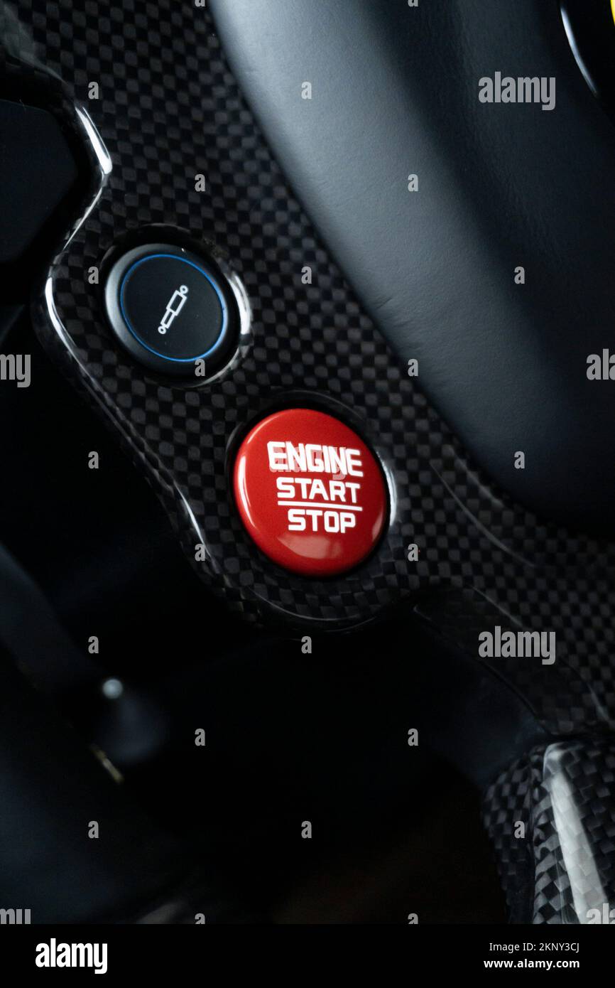 A vertical shot of the red engine button of a Ferrari 488 GTB Stock ...