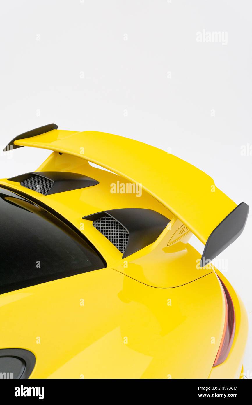 A vertical shot of the rear wing of a yellow Porsche 911 GT3 991.2 Gen ...
