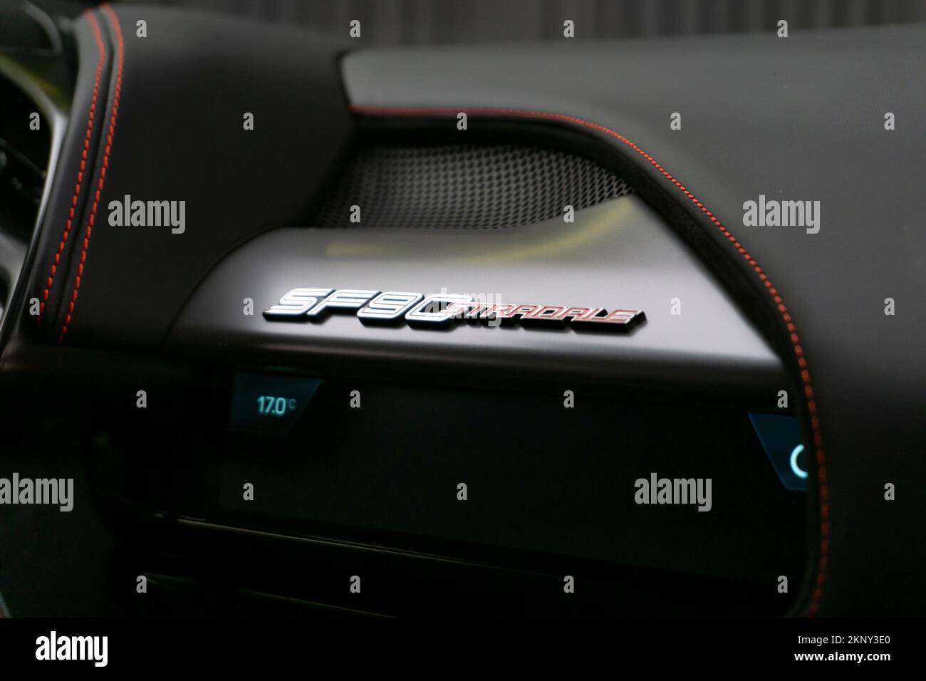 A closeup of a Ferrari SF90 Stradale badge on a dashboard in black ...