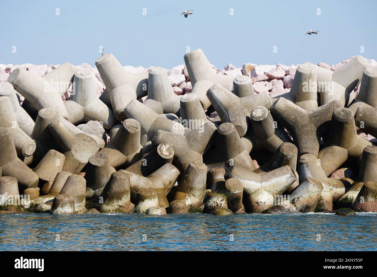 The view of the man-made concrete structure ocean wall by the hill of ...