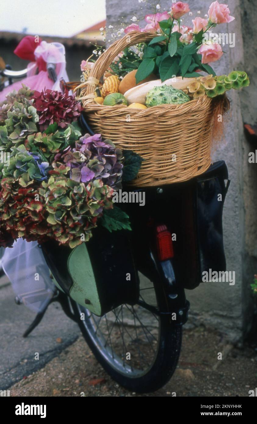 A bicycle carrying a basket of fruits and flower Stock Photo - Alamy