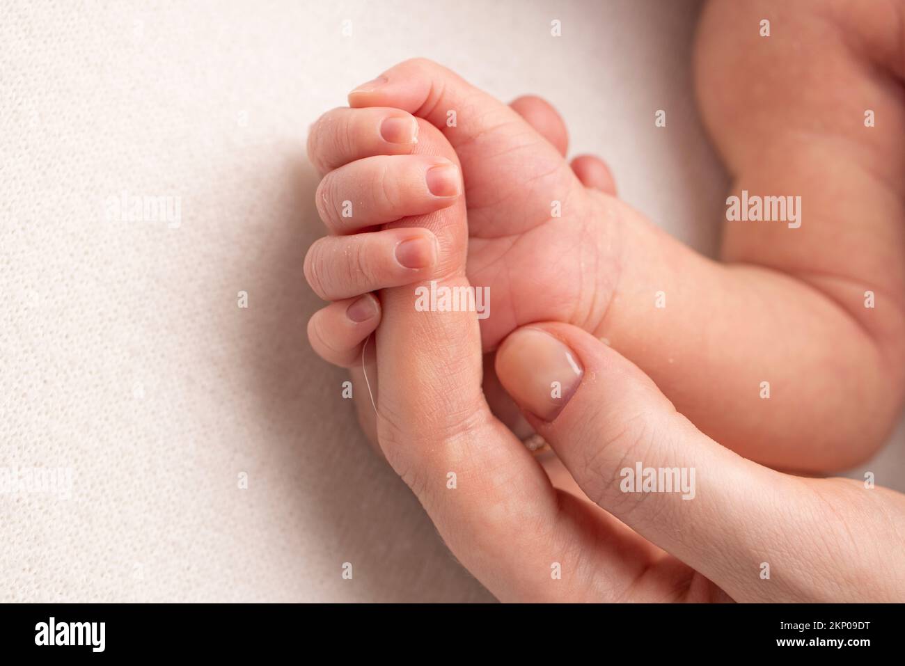 The newborn baby has a firm grip on the parent's finger after birth ...