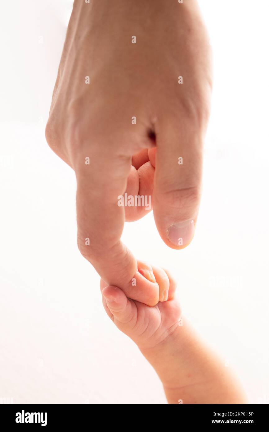 The newborn baby has a firm grip on the parent's finger after birth ...