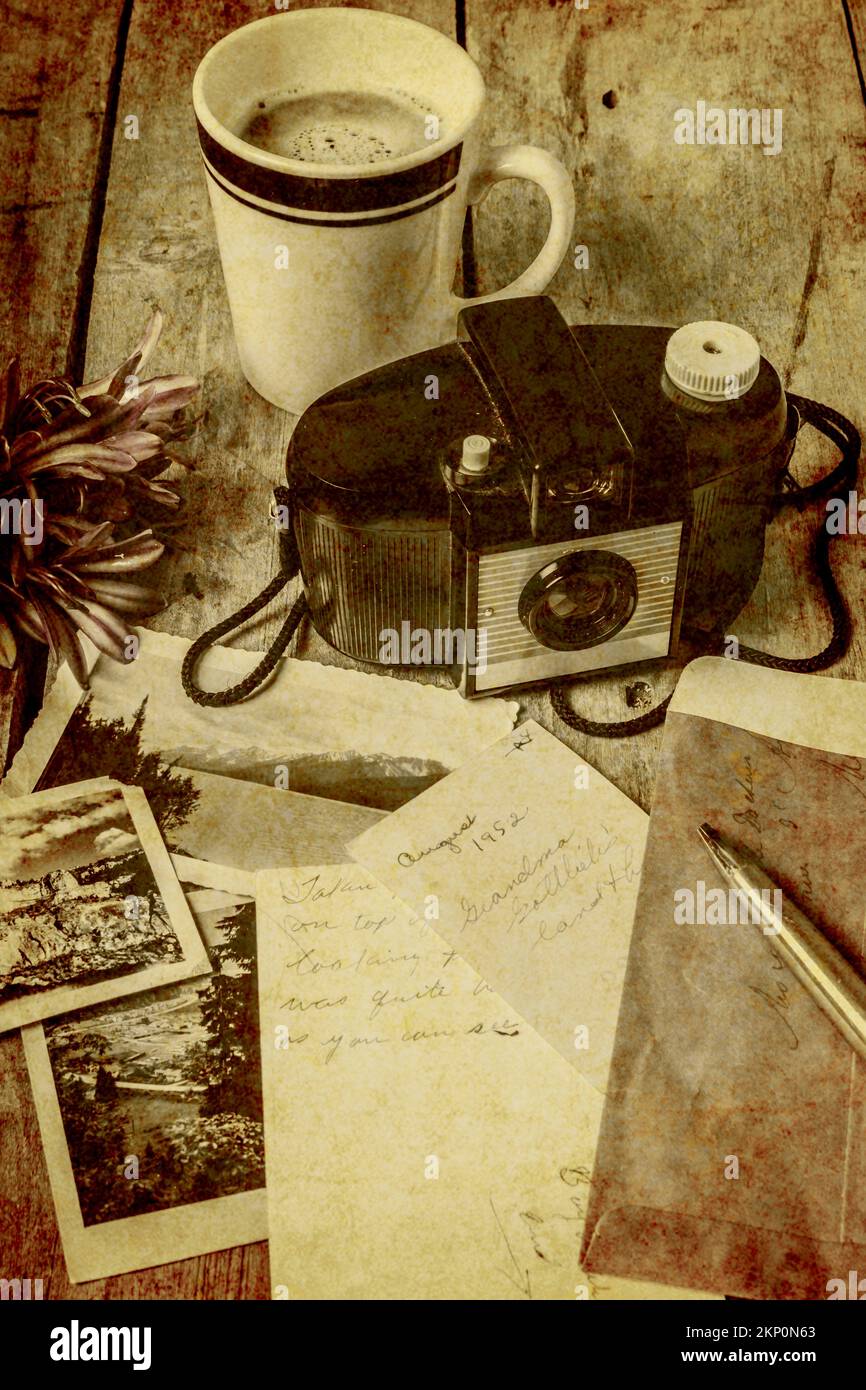 Still life artwork on a scattering of old photos, letters and comforts ...