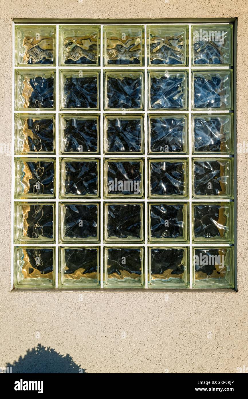 Wavy glass block windows are installed on an exterior wall of a ...
