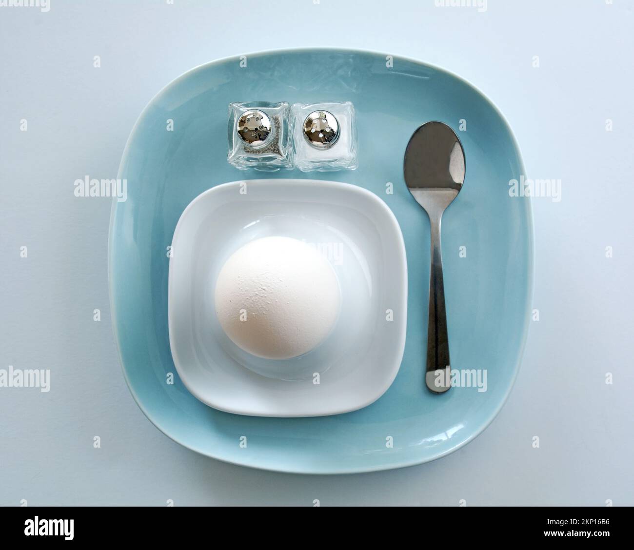 White boiled egg on white and blue china shot from overhead Stock Photo ...