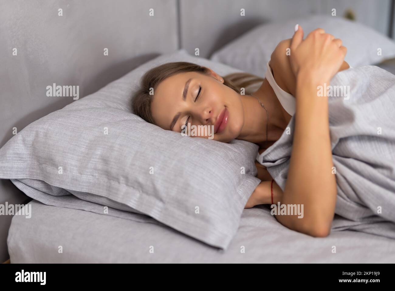 Sleepy female keeping eyes closed while dreaming about future vacation ...