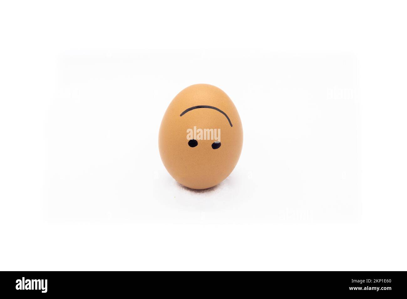 One confused egg on White background Stock Photo - Alamy
