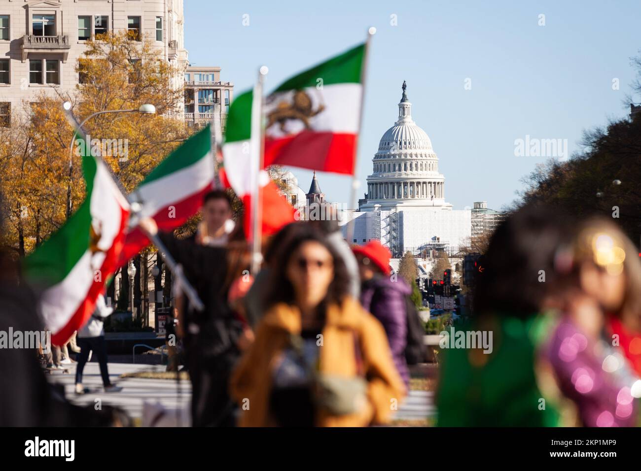 The US Capitol is visible beyond people with Iranian sun and lion flags ...