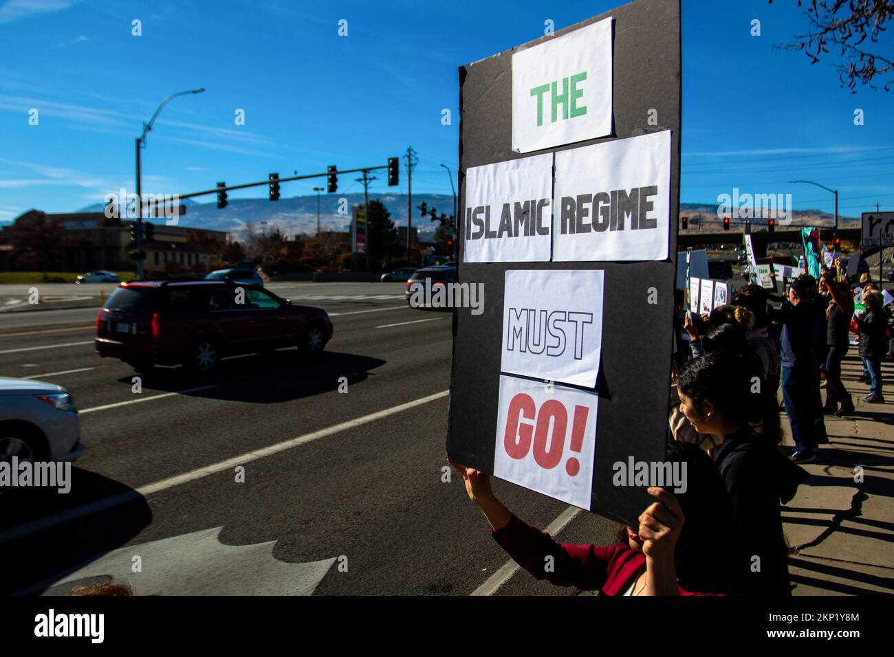 Reno, United States. 27th Nov, 2022. A woman holds a placard against ...