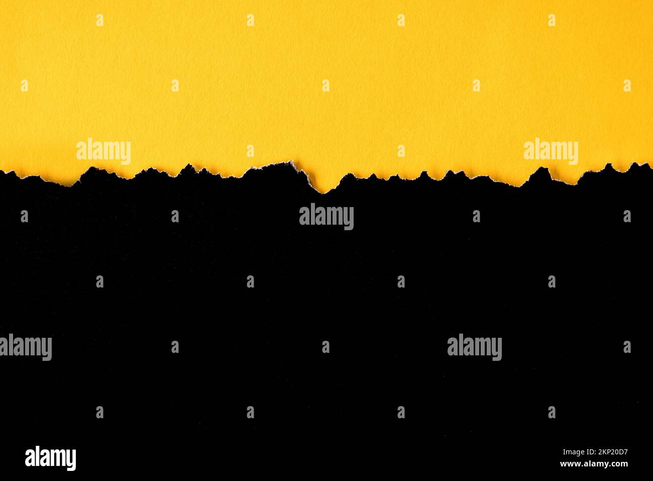 Torn half sheet black paper horizontal on yellow paper at the bottom ...