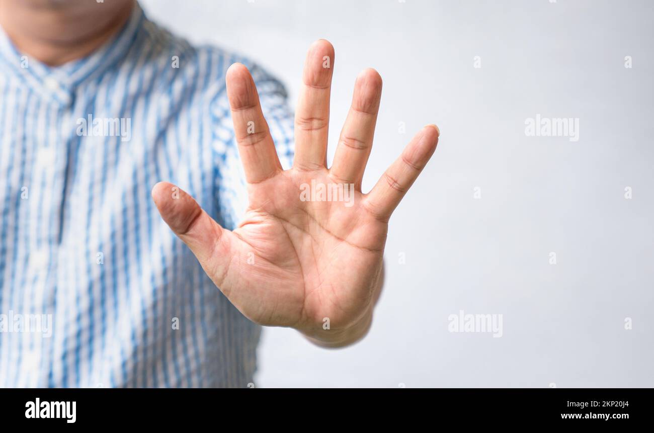 Man showing stop sign gesture with his hand Stock Photo - Alamy