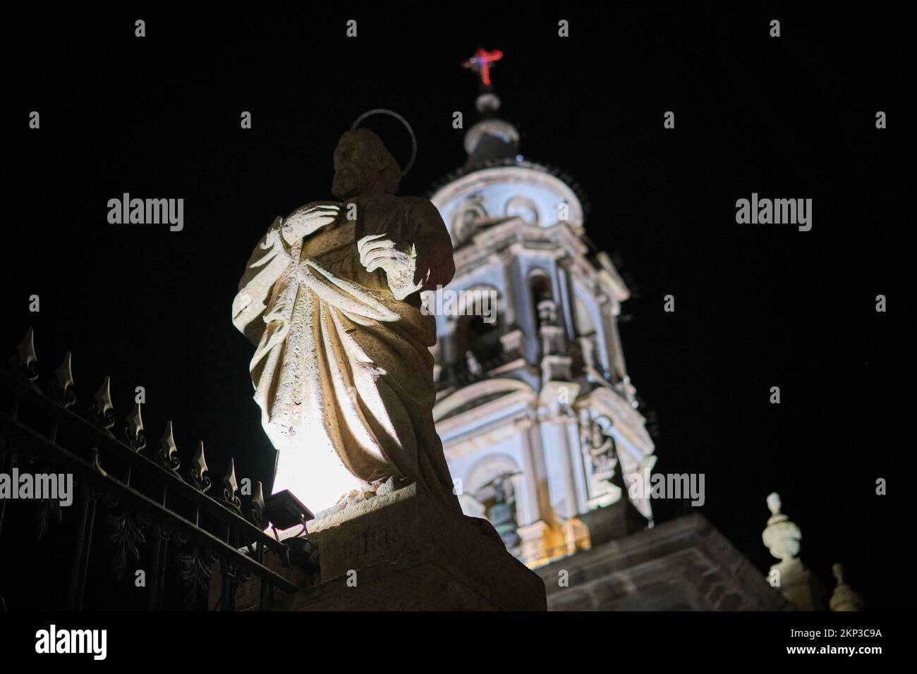 Catholic Church with Apostle in Small Town at Night Stock Photo - Alamy