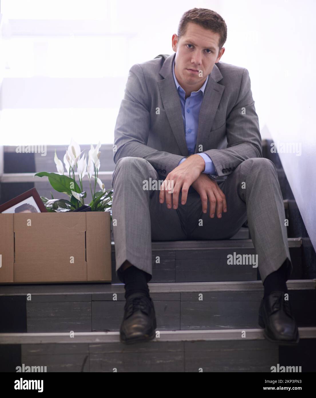 Where did it all go wrong. a despondent businessman with a box of his ...