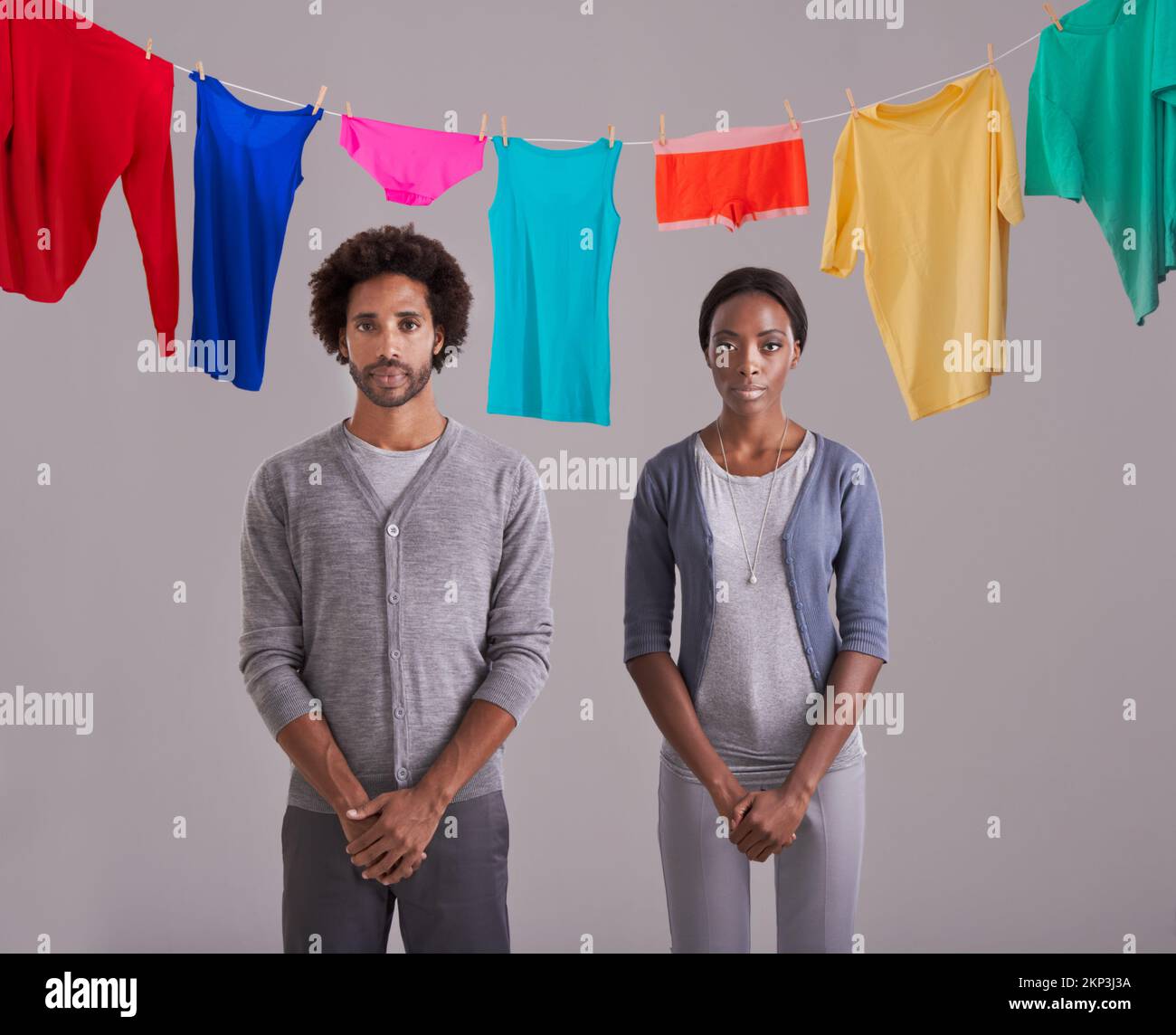 Stuck in the routine of life. Studio shot of a young couple standing in ...