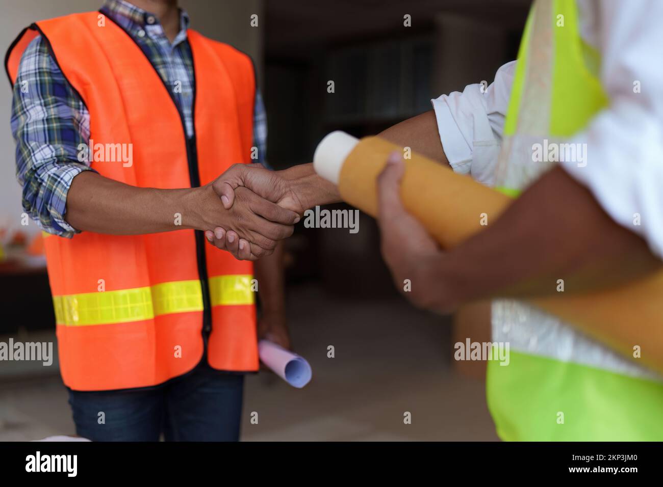 Architect and engineer construction workers shaking hands after finish ...