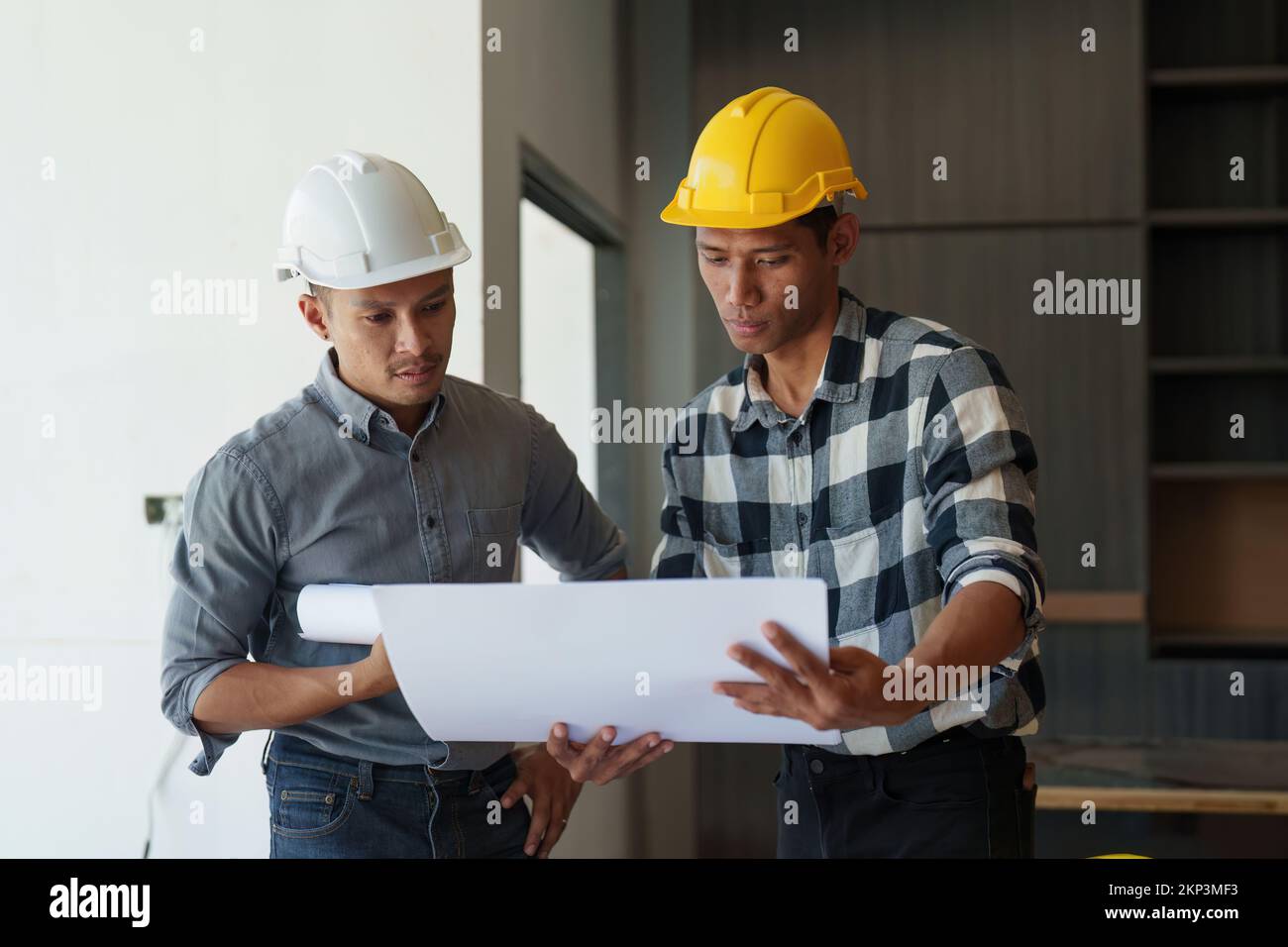 Professional architect designer structural engineer team colleagues discussing building plan ...