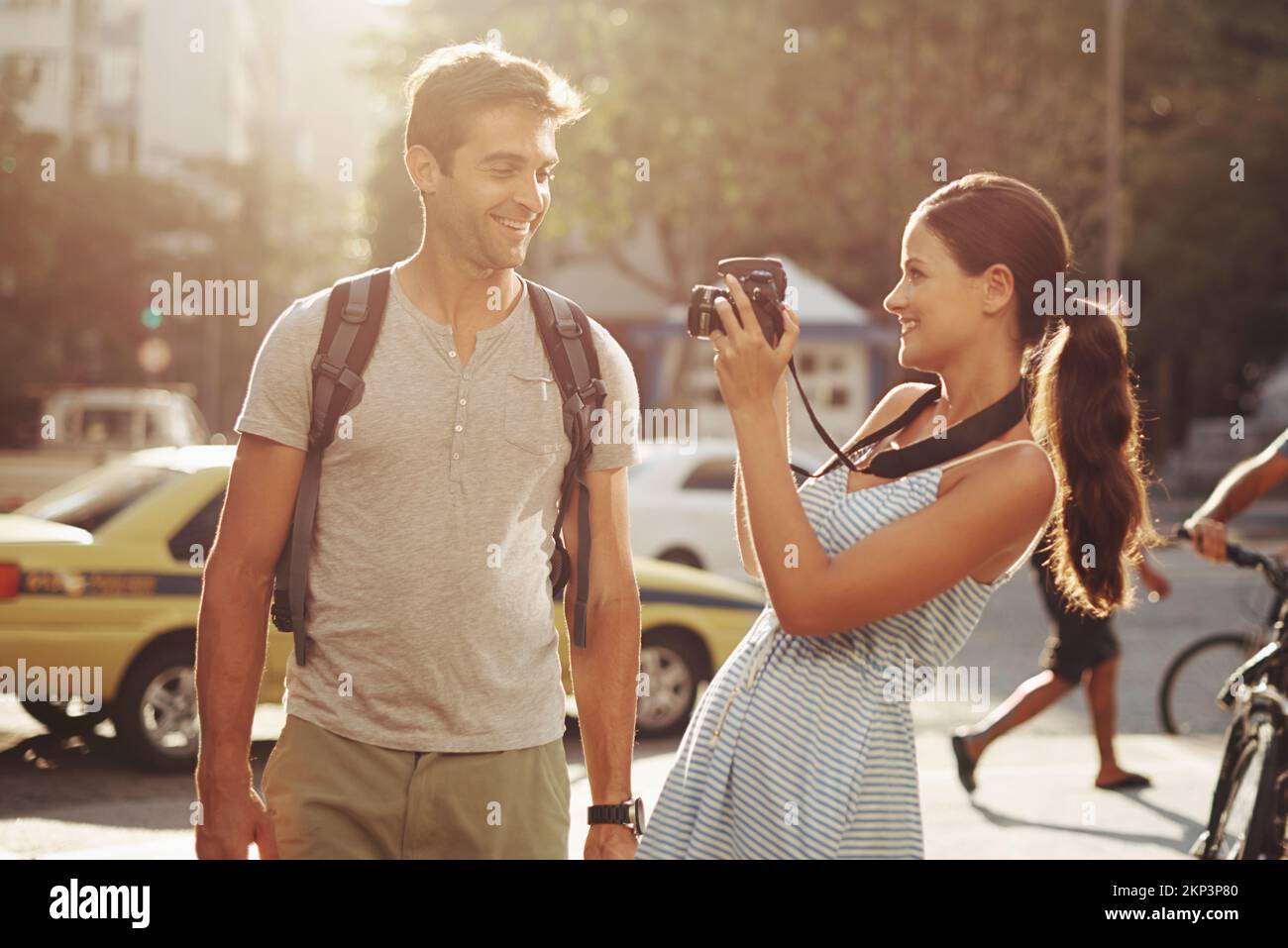 Playful pictures on vacation. a young couple taking pictures while ...