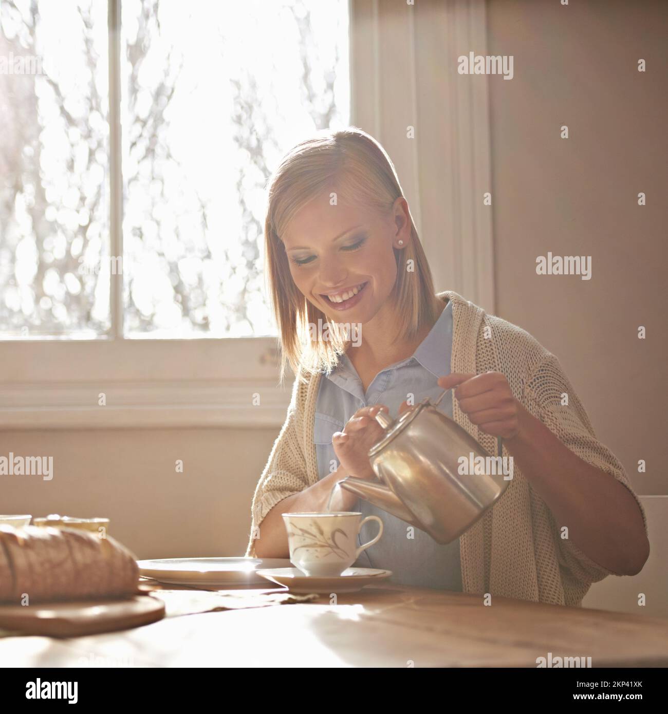 Gorgeous happy woman pouring tea hi-res stock photography and images ...