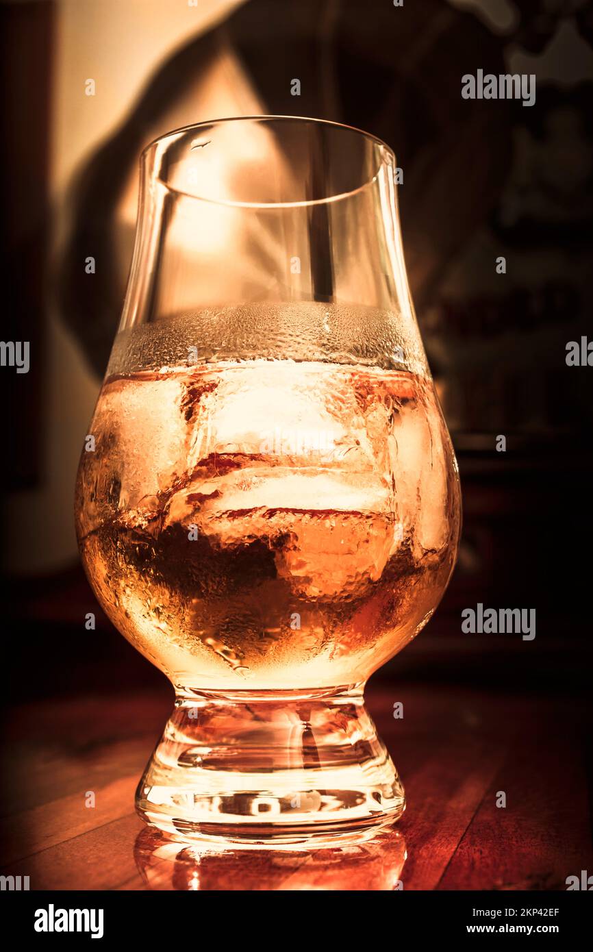 Low angle view on an exquisite glass of cognac in a half filled snifter ...