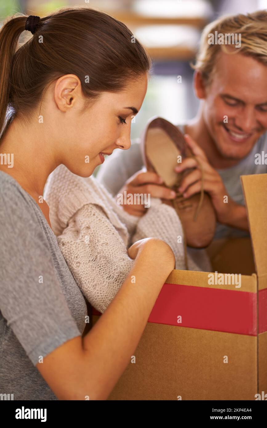 Packing partners. a young couple unpacking boxes on moving day Stock ...