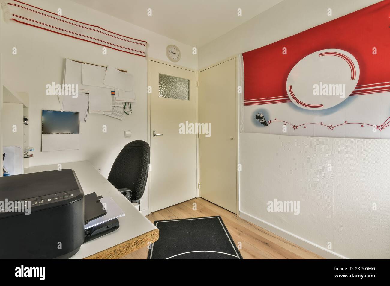 Comfortable chair placed near desk with printer and whiteboard in light ...