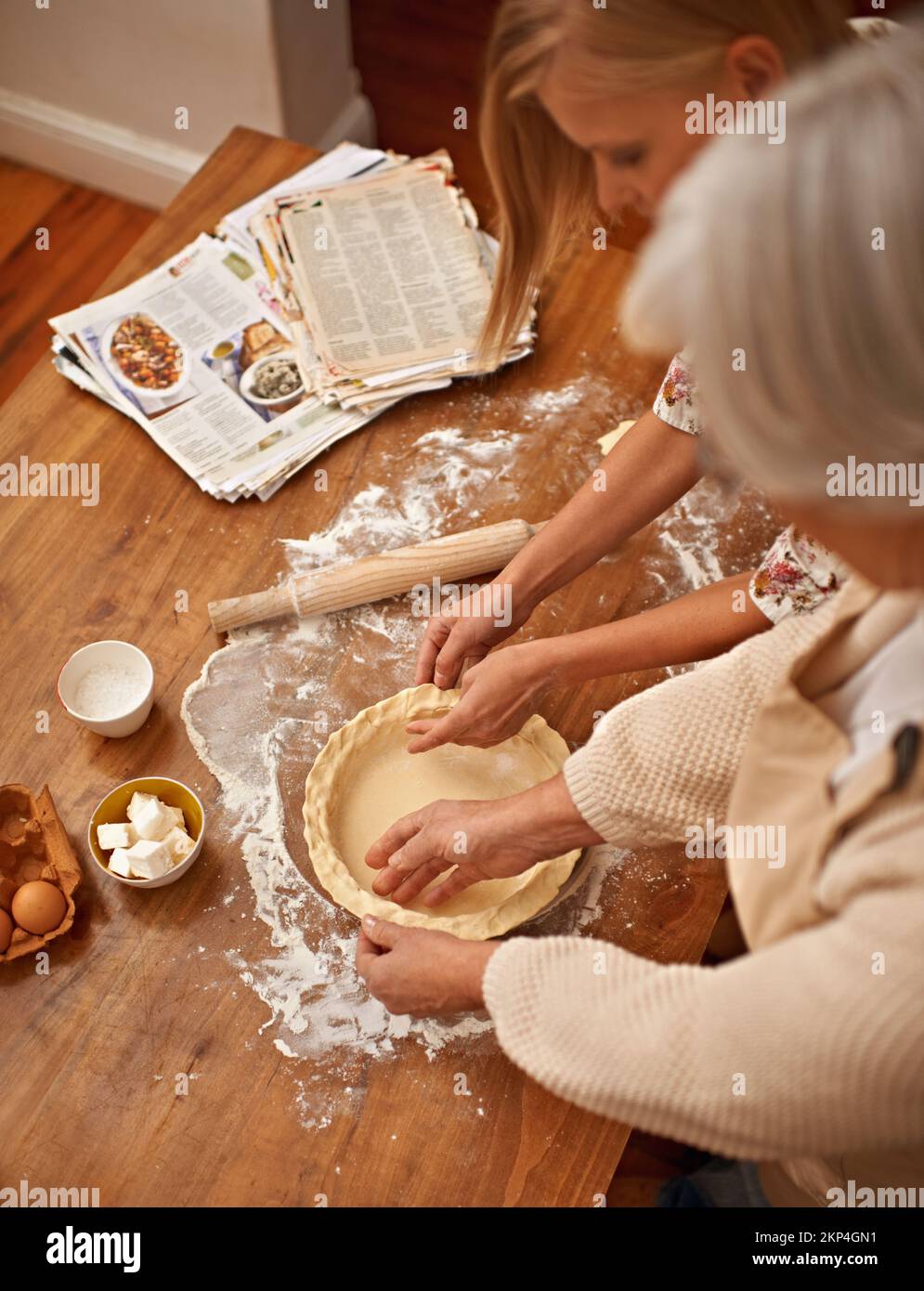 Adding the finishing touches before baking. a young woman learning ...